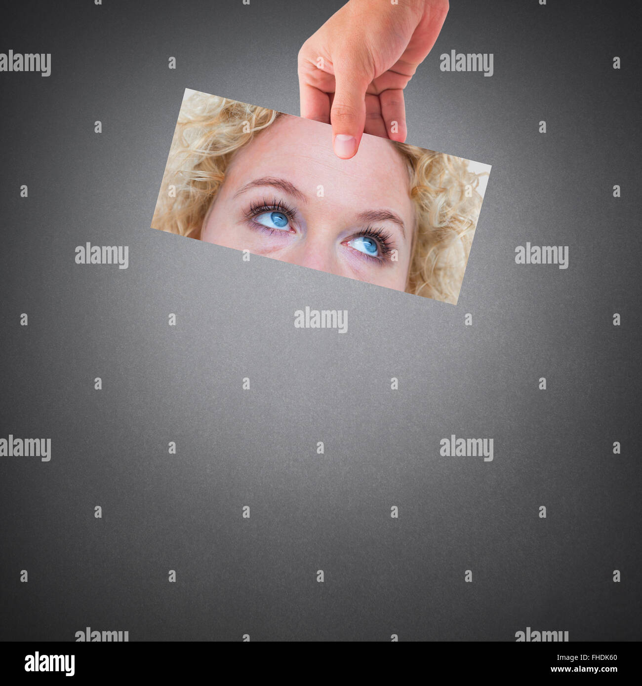 Composite image of hands showing photo of eyes Stock Photo - Alamy