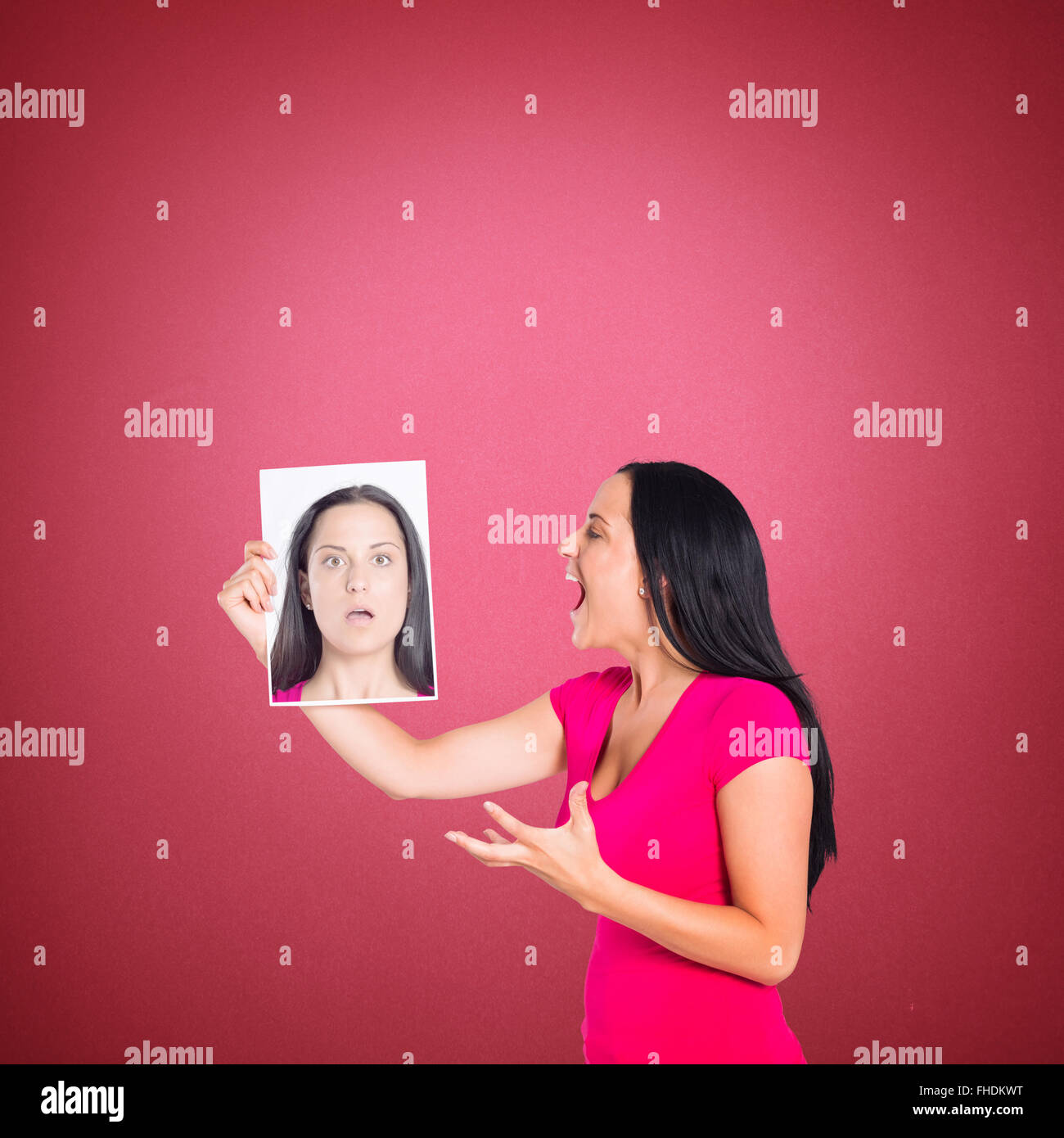 Composite image of woman shouting at picture of herself Stock Photo - Alamy