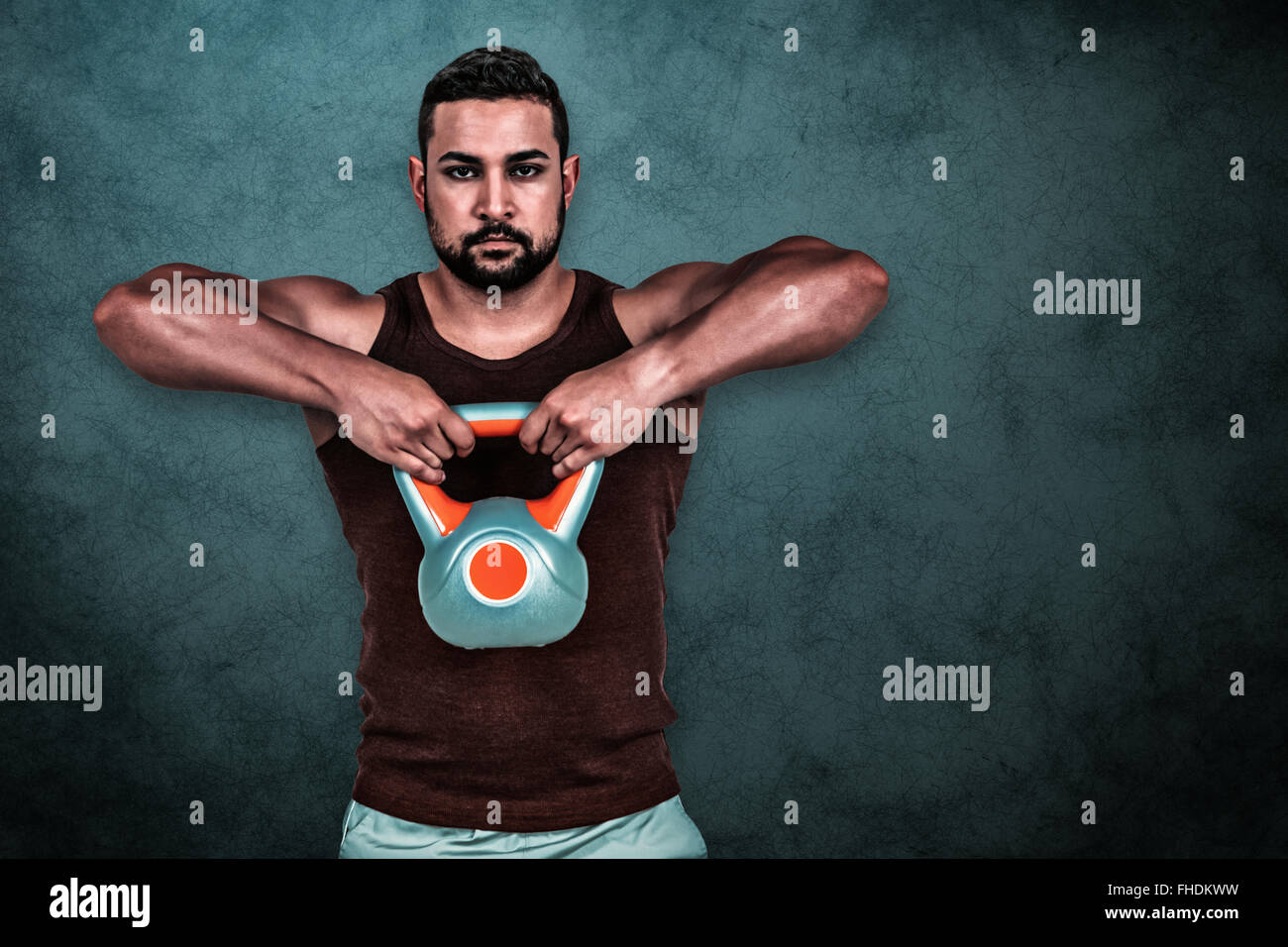 Composite image of muscular serious man lifting a kettlebell Stock ...