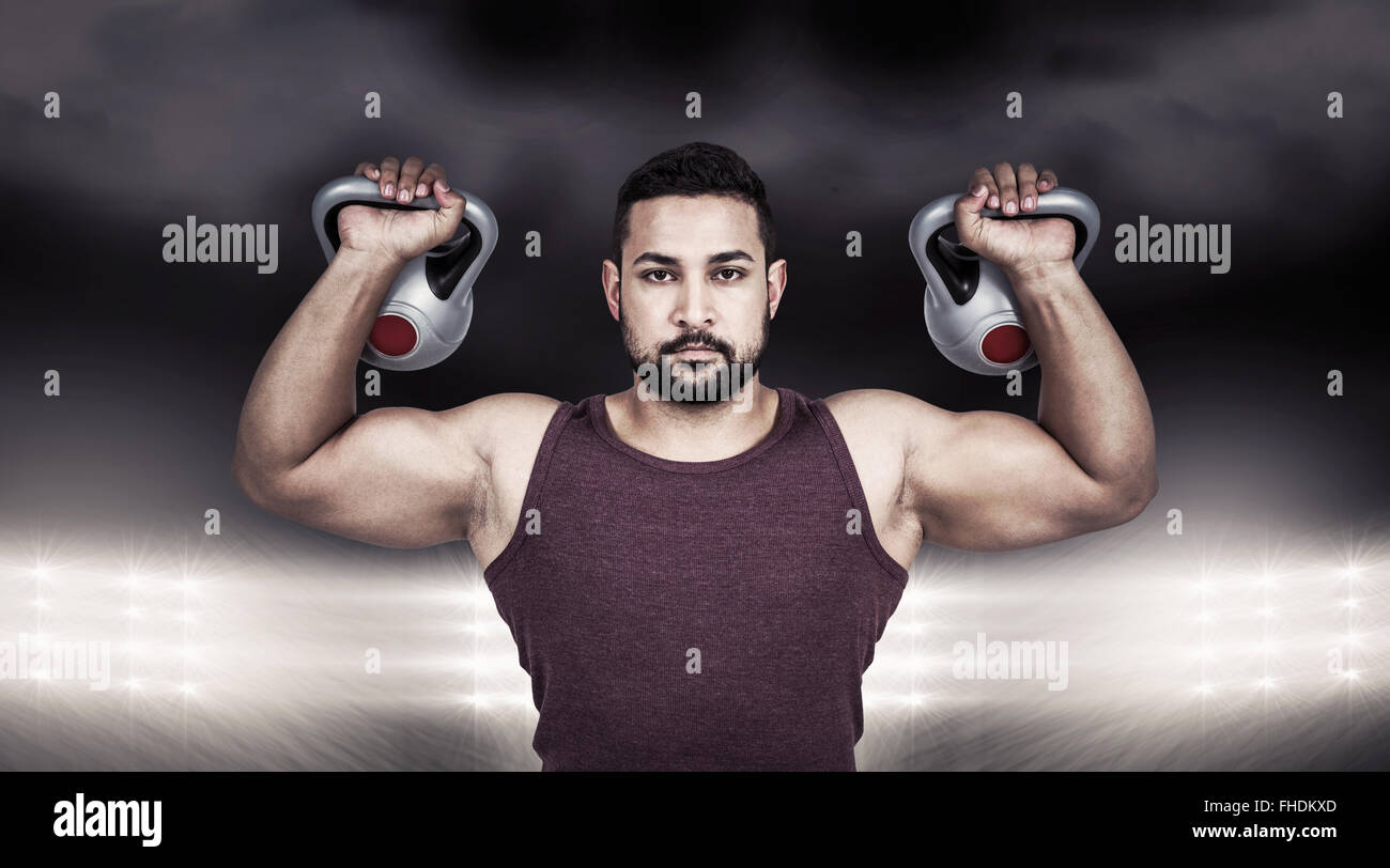 Composite image of muscular serious man lifting kettlebells Stock Photo ...
