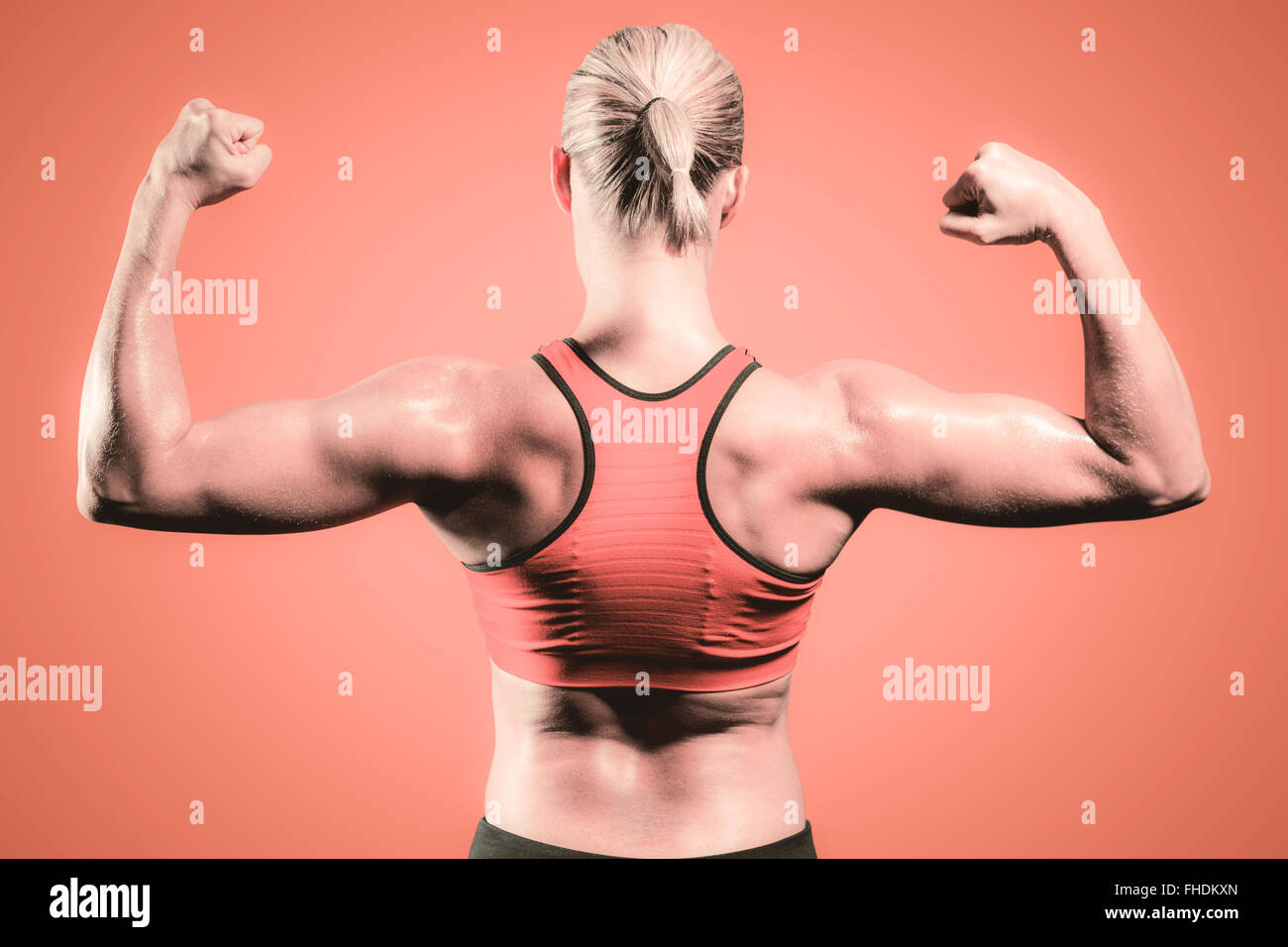 Composite image of muscular woman flexing her arms Stock Photo - Alamy