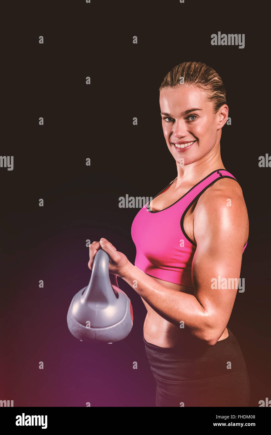 Composite image of muscular woman lifting heavy kettlebell Stock Photo ...