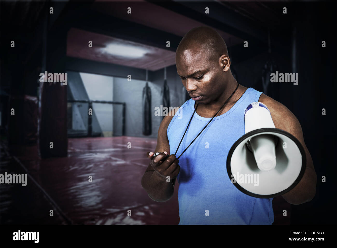 Composite image of fit trainer checking his stopwatch Stock Photo - Alamy