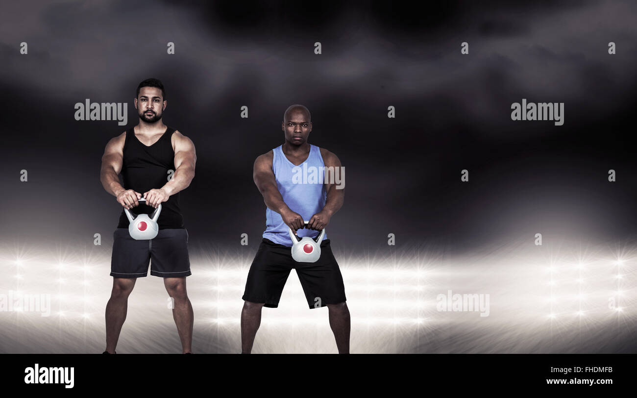 Composite image of strong friends lifting kettlebells together Stock ...