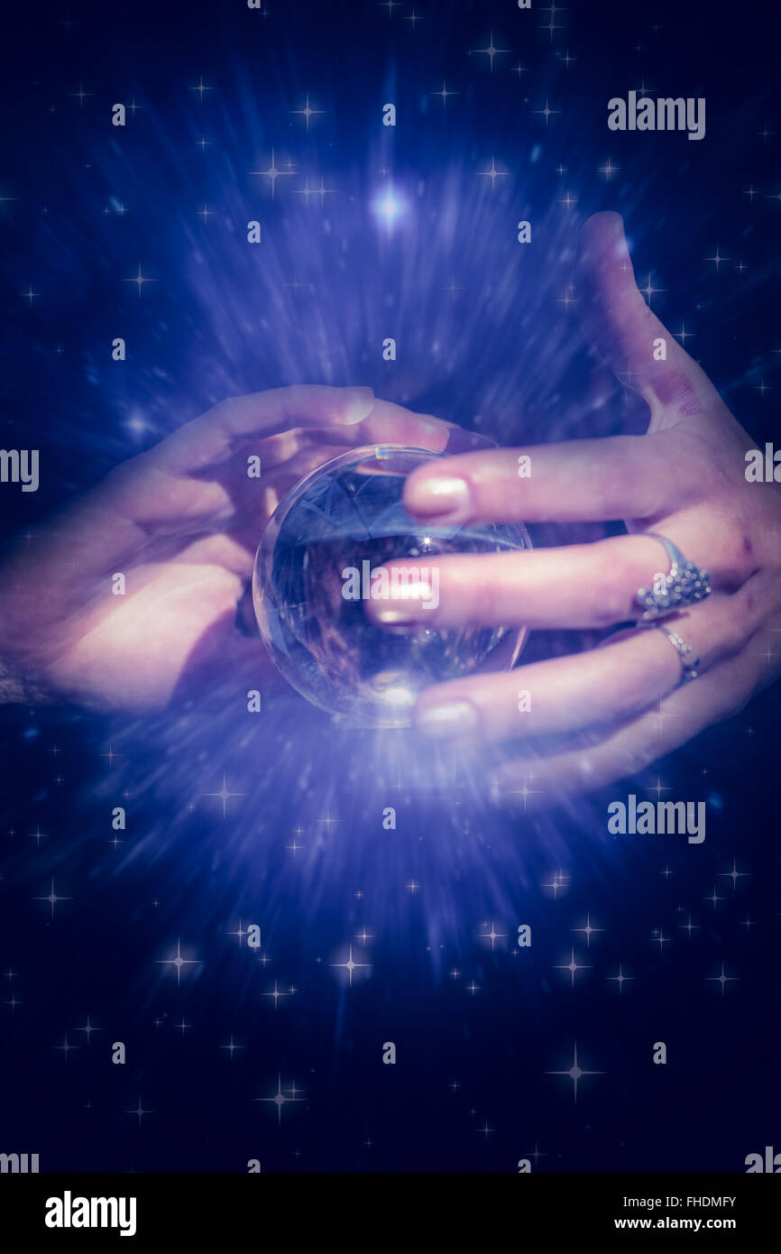 Composite image of woman using crystal ball Stock Photo - Alamy