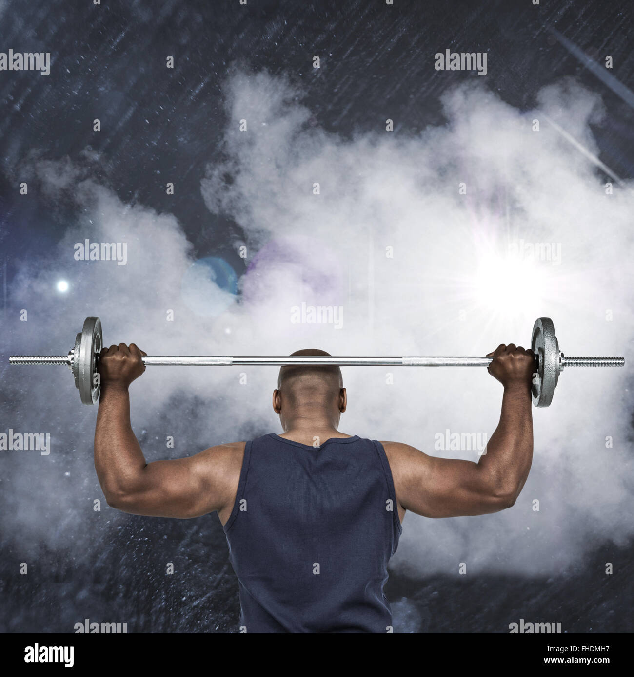 Composite image of fit man lifting heavy barbell Stock Photo - Alamy