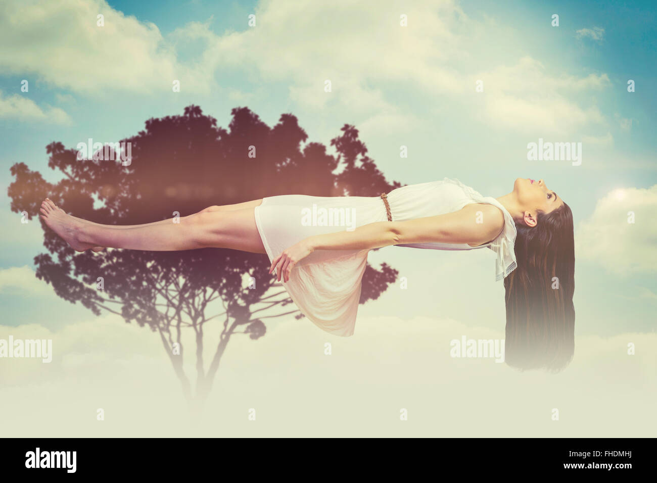 Composite image of girl in white dress floating in air Stock Photo - Alamy