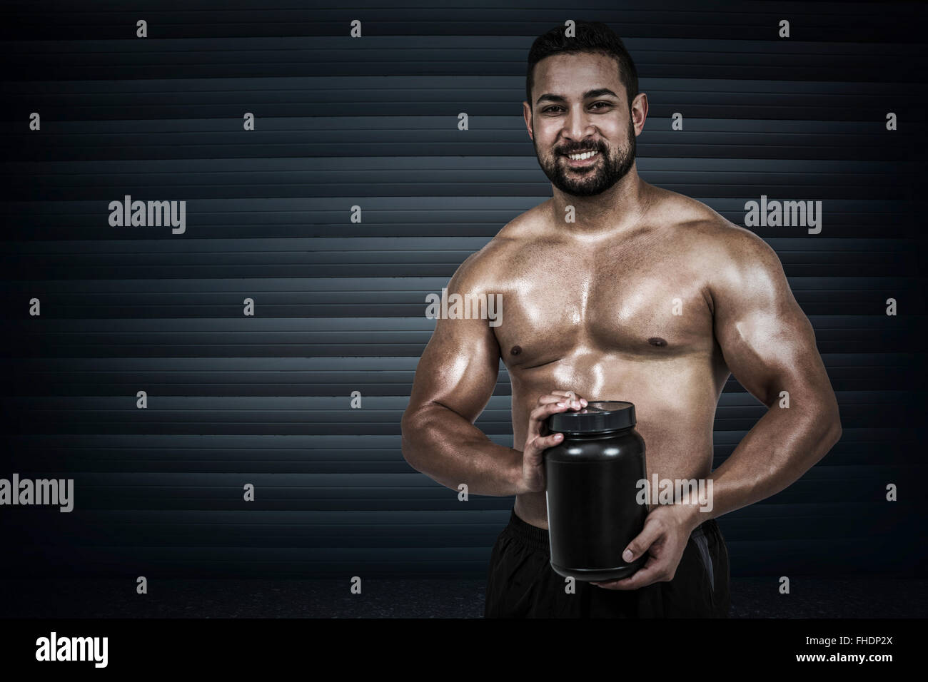 Composite image of muscular man with protein powder Stock Photo - Alamy