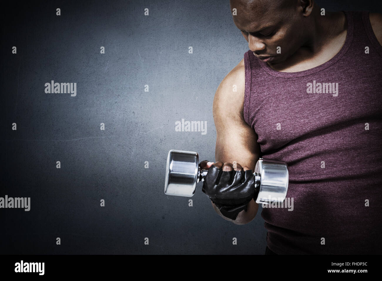 Composite image of fit man exercising with dumbbell Stock Photo - Alamy