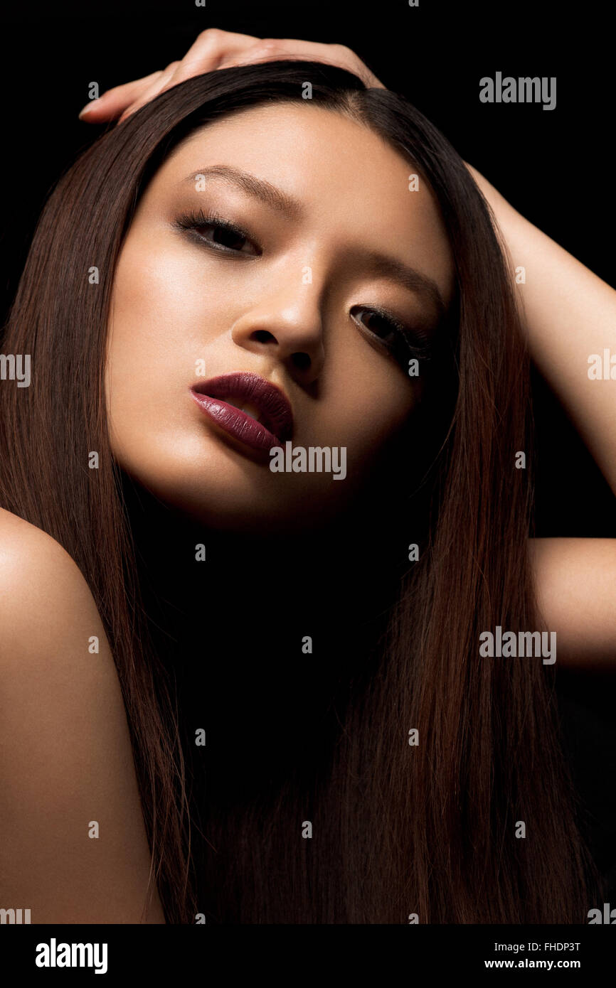 Asian model wearing red lipstick and gold eye shadow Stock Photo - Alamy
