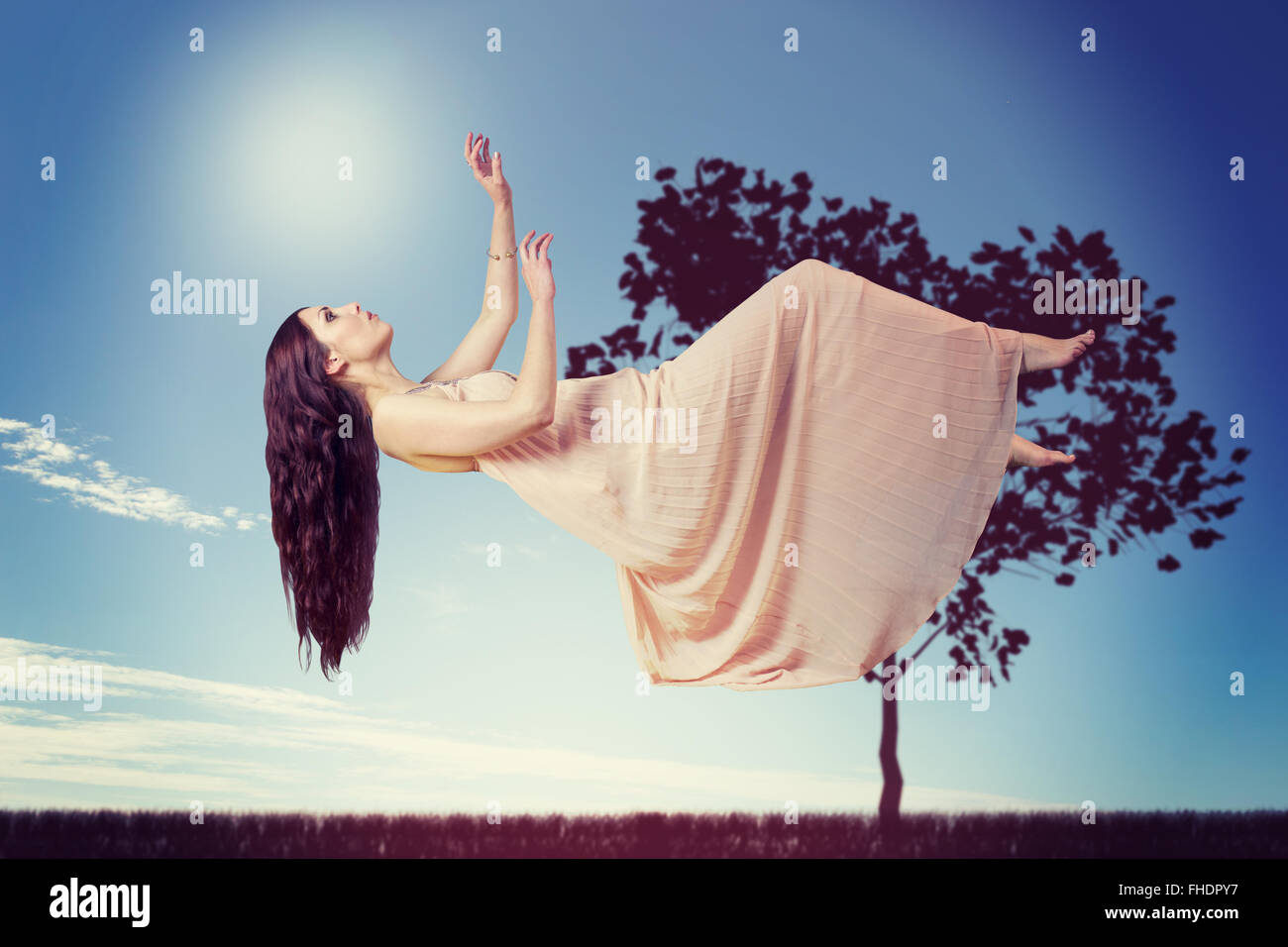 Composite image of full length of woman flying Stock Photo - Alamy