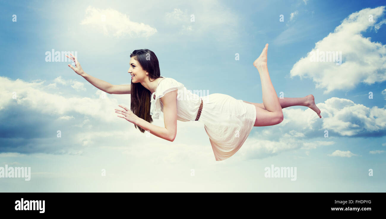 Composite image of girl in white dress floating in air Stock Photo - Alamy