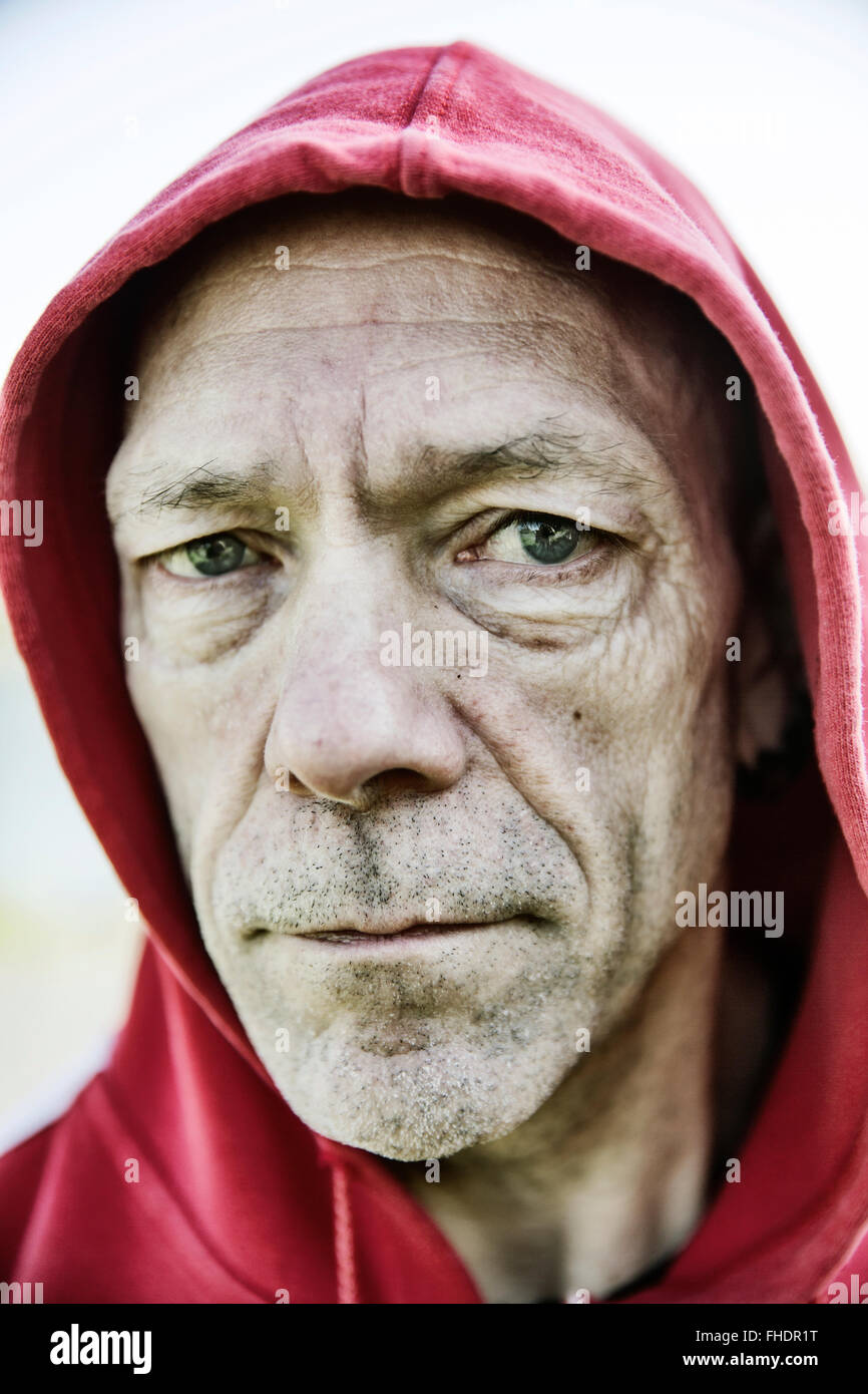 Portrait of man with red hood Stock Photo - Alamy