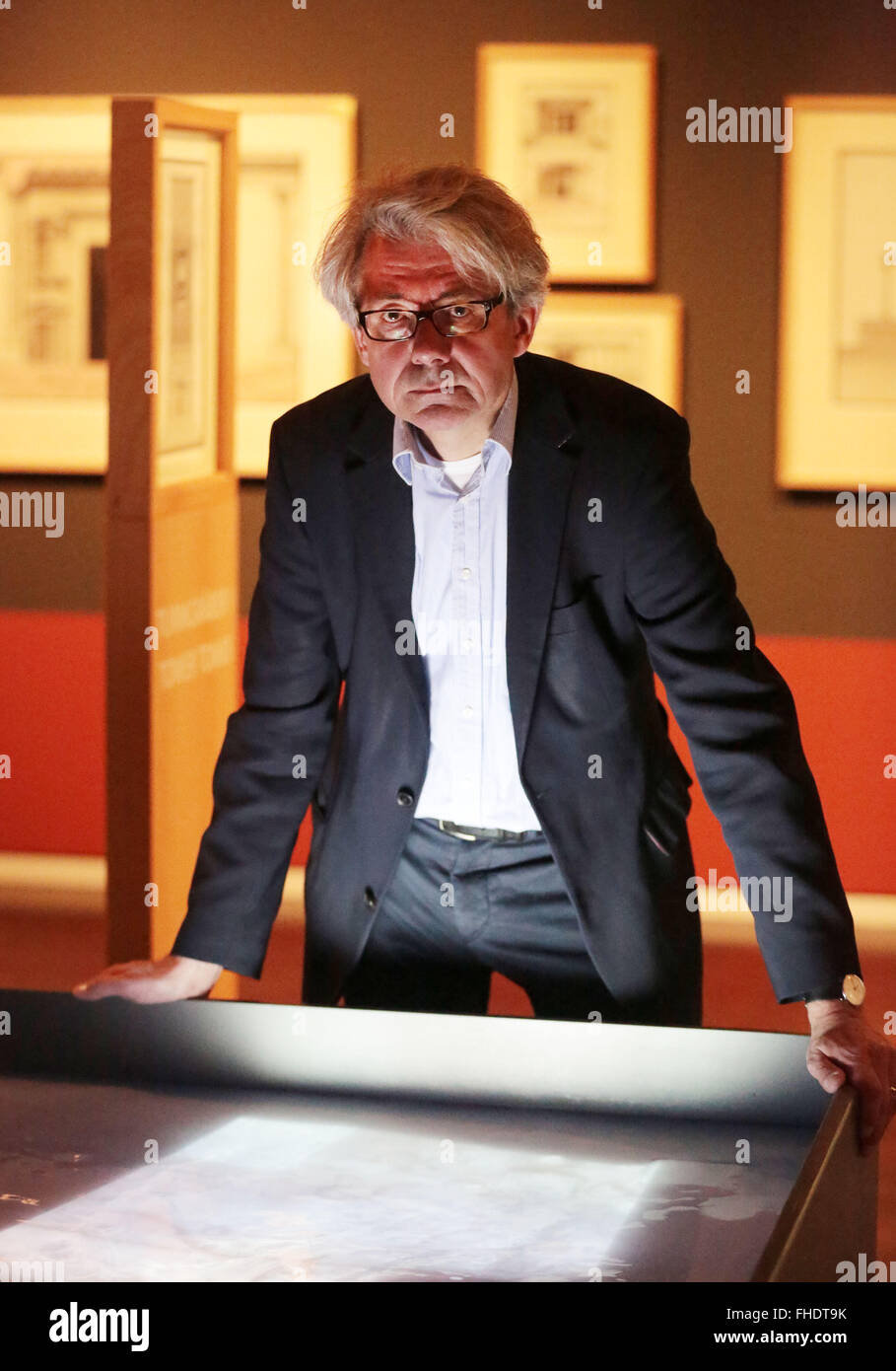 Cologne, Germany. 23rd Feb, 2016. Curator Thomas Ketelsen poses next to graphics in the ...