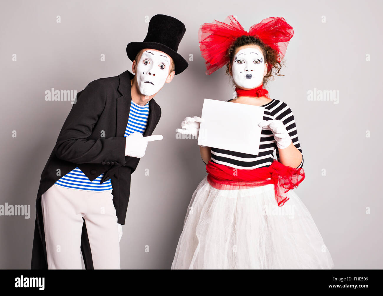 Two mimes with a sign for advertising Stock Photo - Alamy