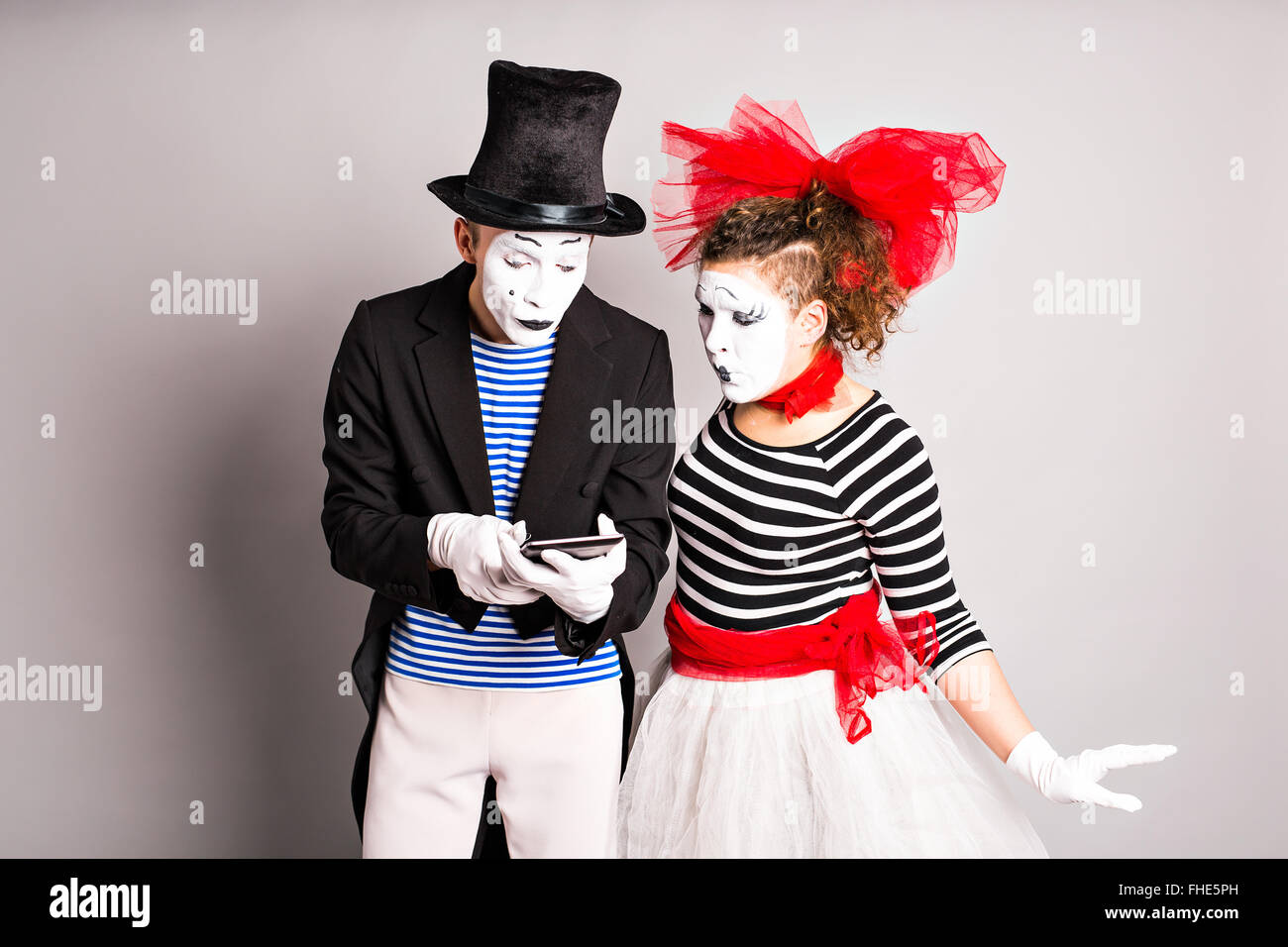 Two actors using digital tablet over white background. Horizontal shot ...