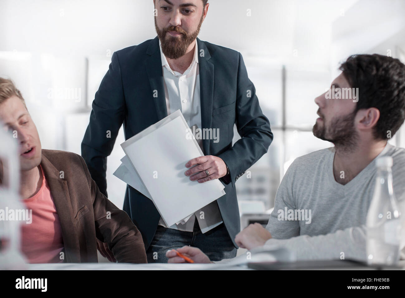 Three men in office working together Stock Photo - Alamy