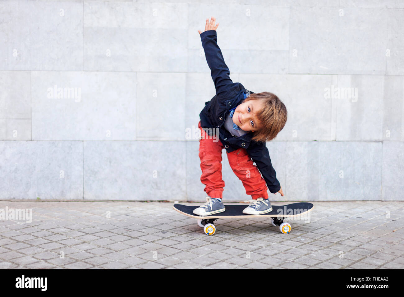 Portrait of little boy balancing on skateboard Stock Photo - Alamy