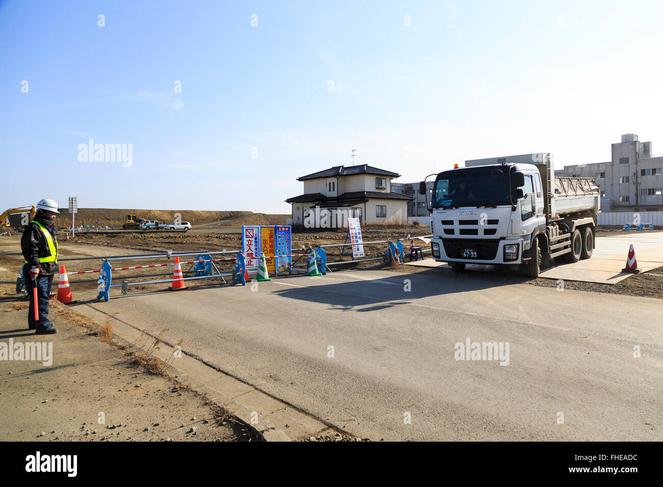 A construction worker patrols the entrance to a reconstruction zone ...