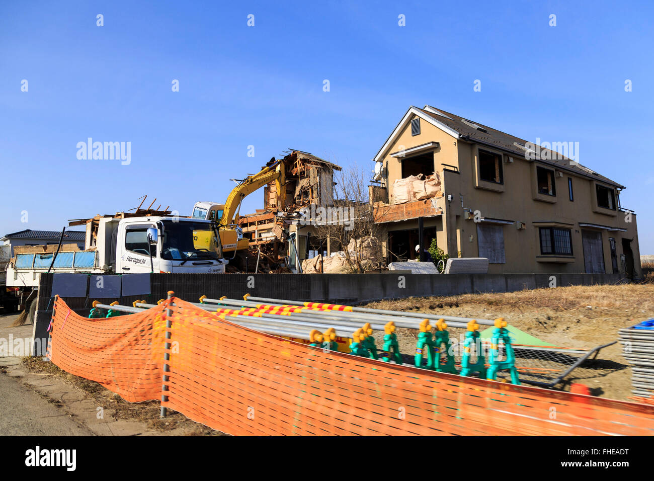 Construction trucks and bulldozers work in one of the areas affected by ...