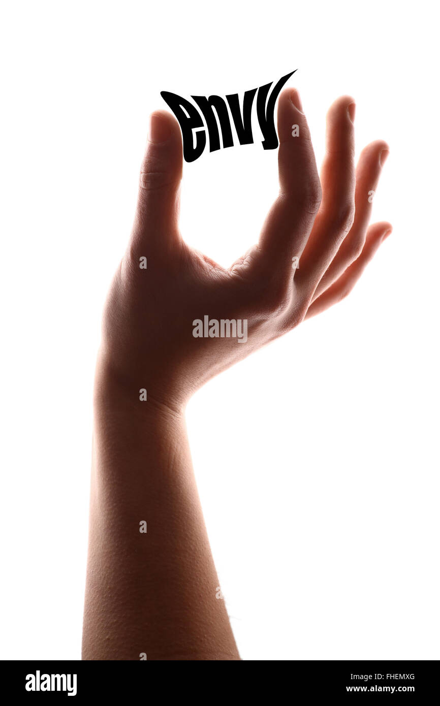 Color vertical shot of a hand squeezing the word "envy Stock Photo - Alamy