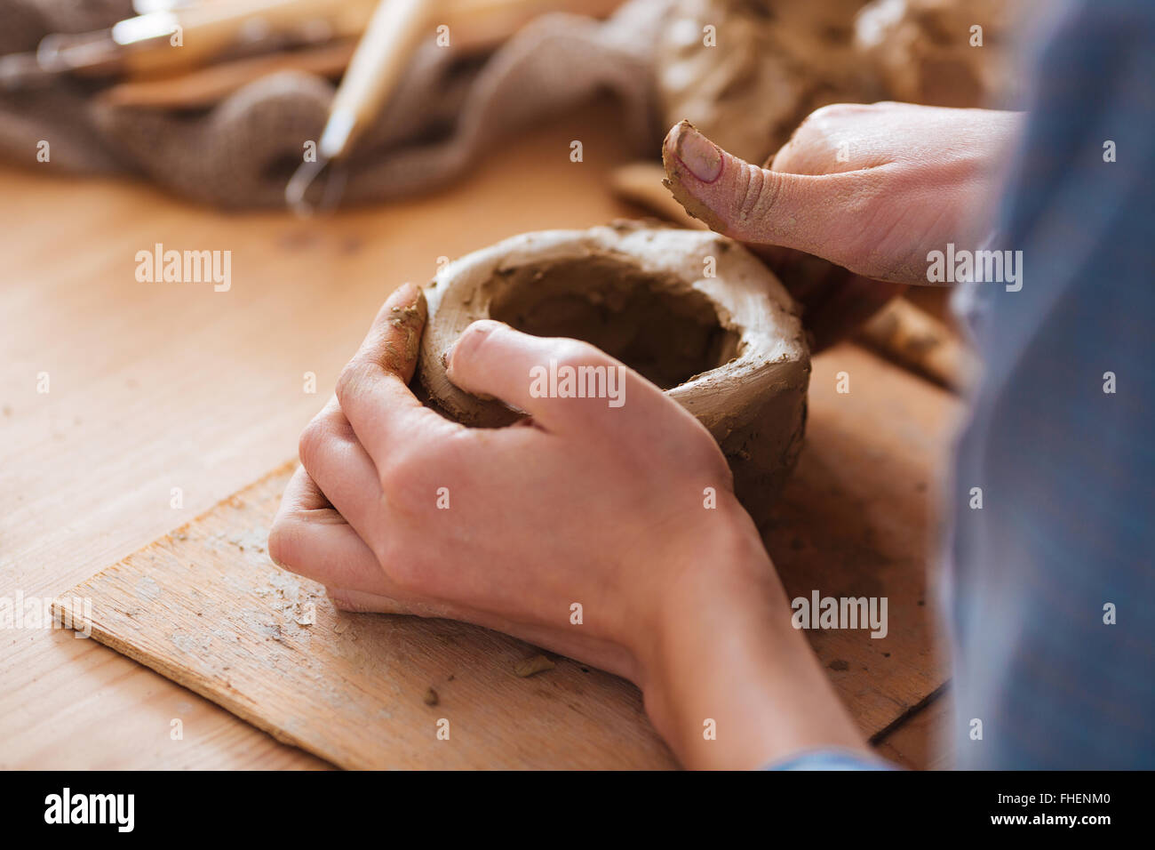 Closeup of woman hands making pot using clay in pottery studio Stock ...