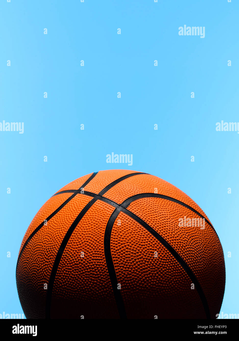 Single Basketball isolated on a blue background Stock Photo - Alamy