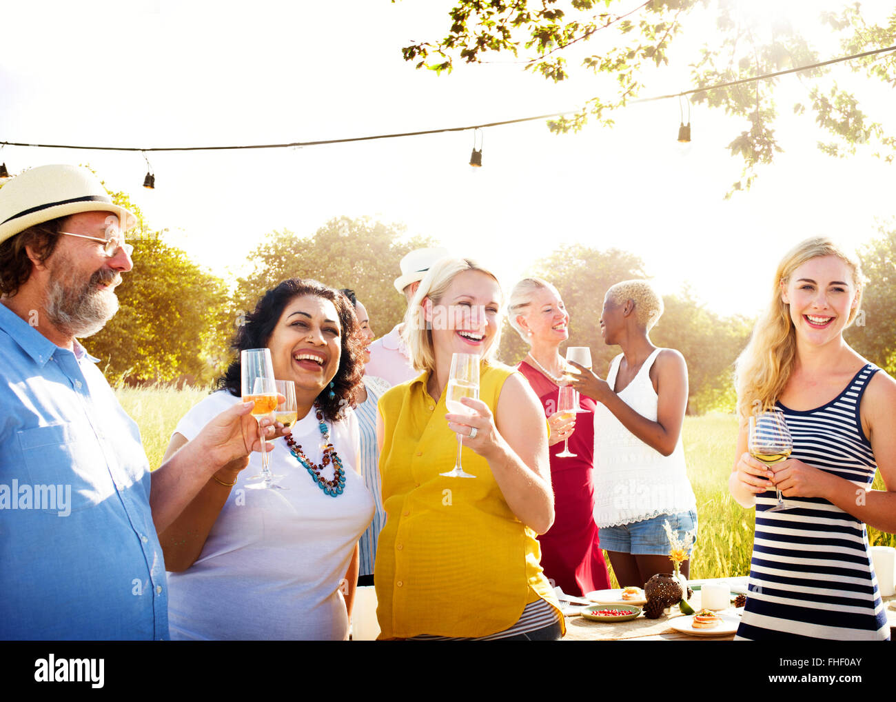 Diverse group drinking champagne park hi-res stock photography and ...