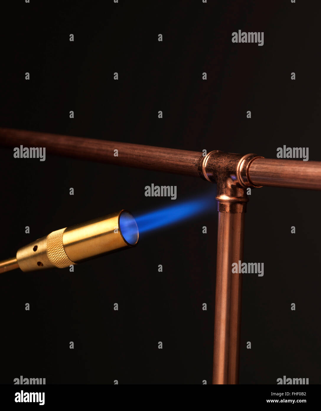 Blowtorch with flame on a black background Stock Photo - Alamy