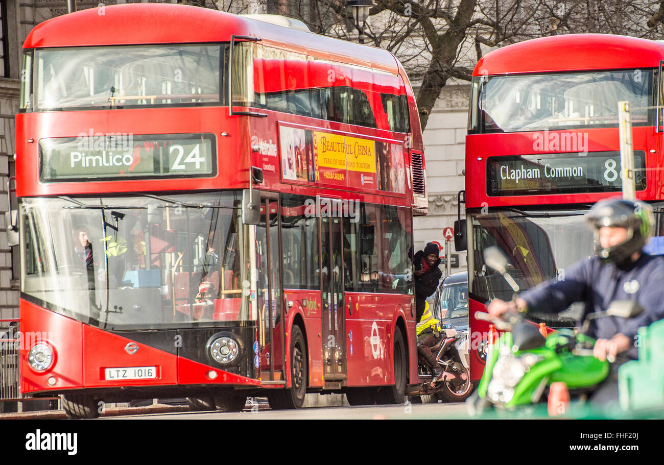 Man leaning out of London bus Stock Photo - Alamy