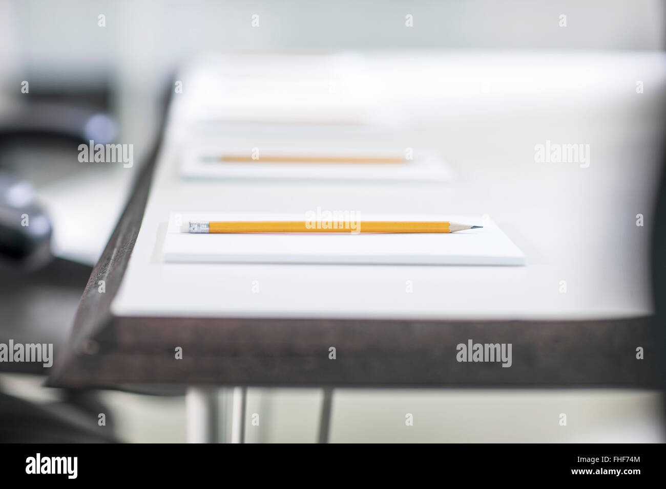Pencils and note pads on conference table Stock Photo - Alamy