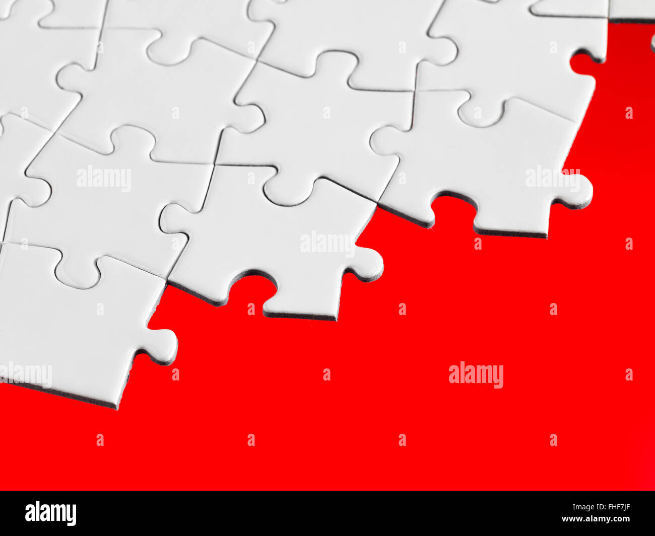 Jigsaw pieces with a red background Stock Photo - Alamy
