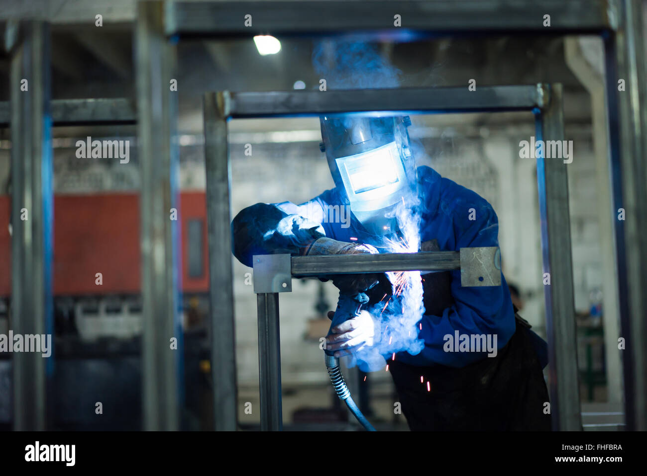 front close-up of a worker wearing a full protective gear, with mask ...