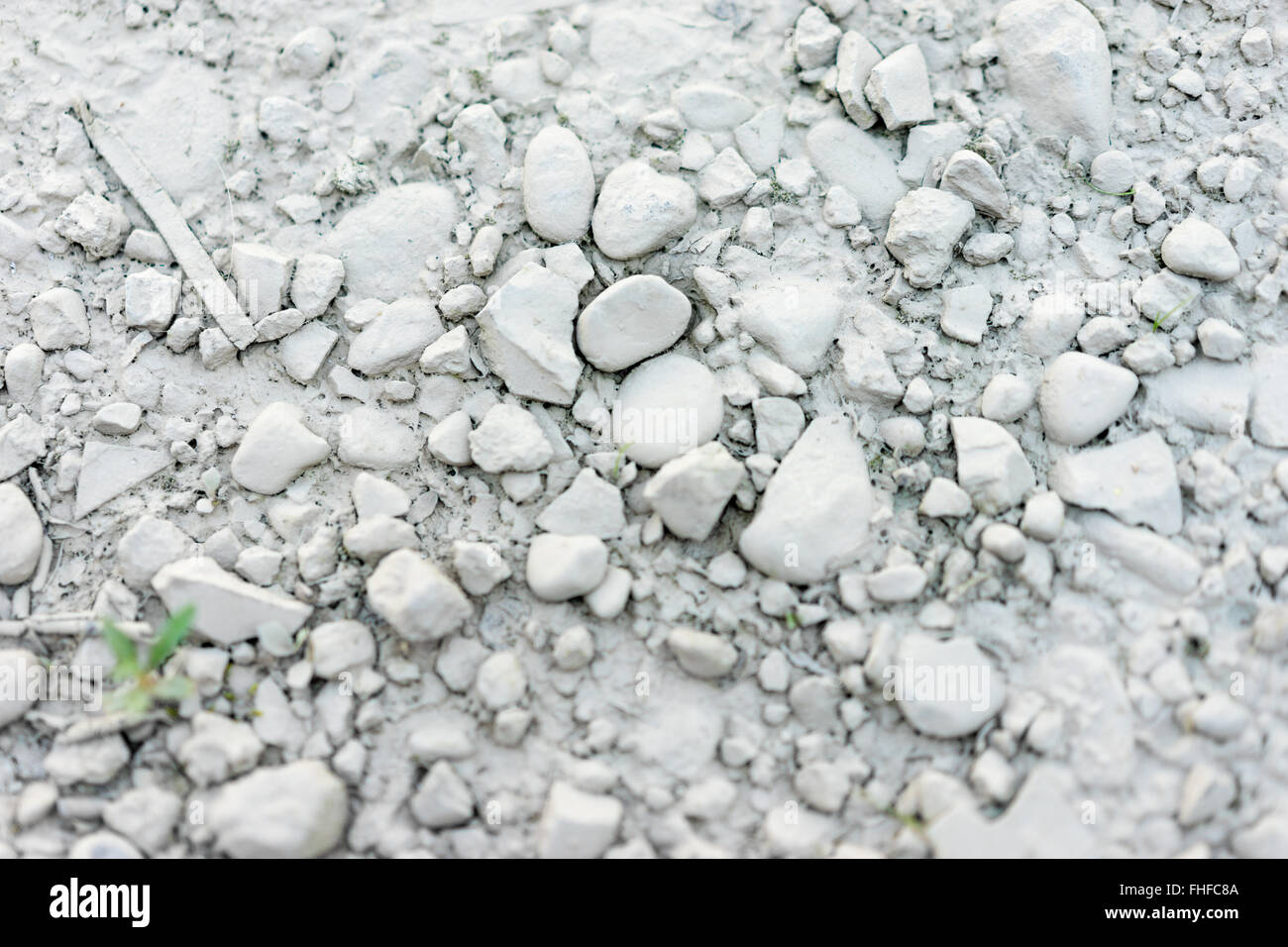 entire image of ground covered in pebbles and a layer of very fine grey ...
