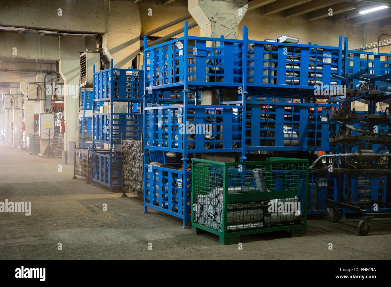 view of an industrial hall, with big blue, green, and grey metallic ...