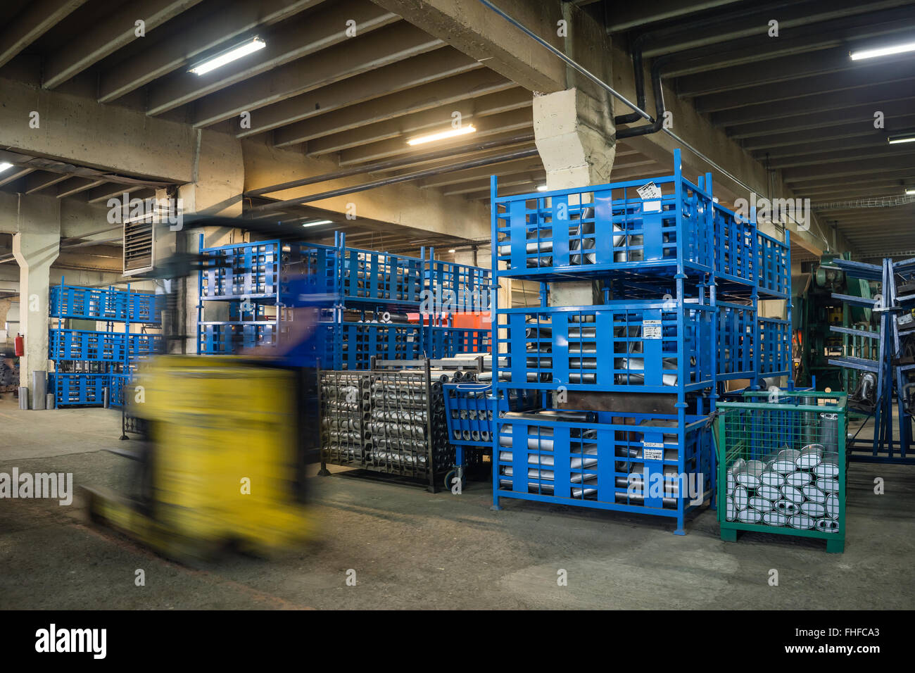 long exposure picture of an industrial hall, with big blue, green, and ...