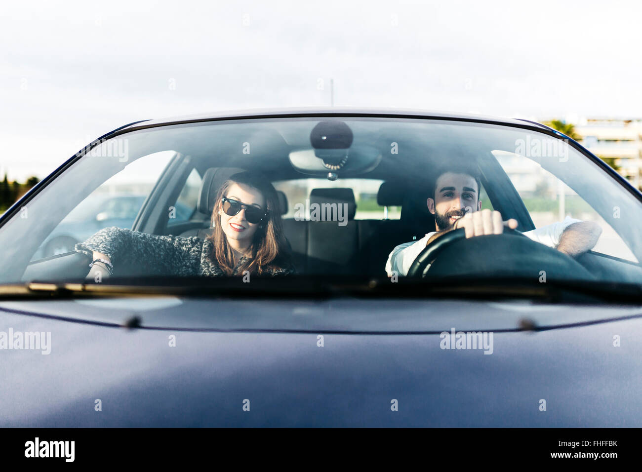 Young couple driving in a car Stock Photo - Alamy