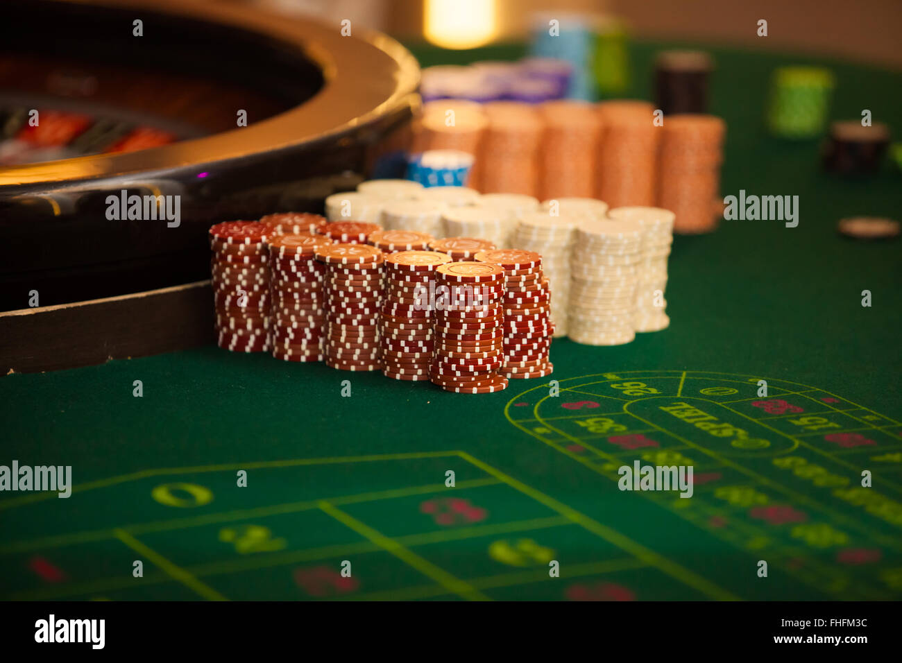 green roulette table with collored chips ready to play Stock Photo - Alamy