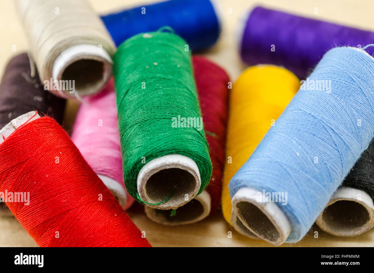 Sewing thread in various colors on a pile Stock Photo - Alamy