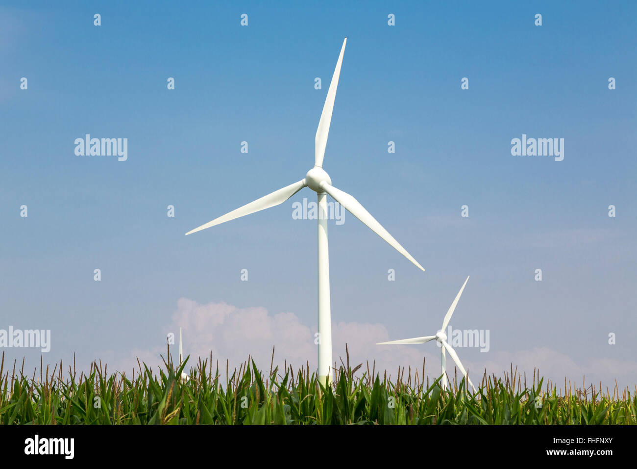 wind wheels on blue sky with cornfield Stock Photo - Alamy