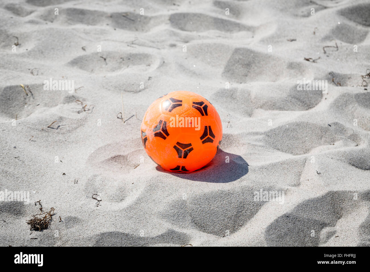 orange plastic soccer ball laying at the beach Stock Photo - Alamy