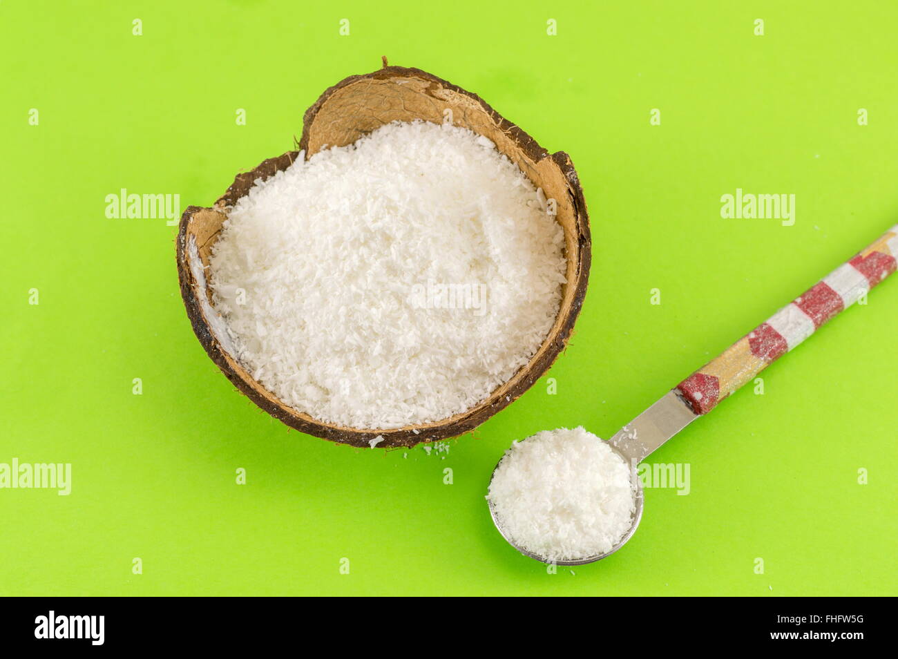 Coconut powder in coconut shell and fresh coconut on green background ...