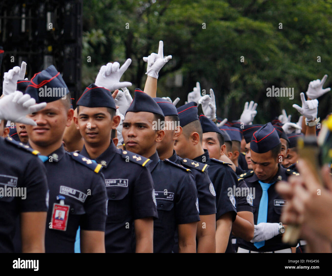 Filipinos gesture Laban sign as they participate in the celebration of ...