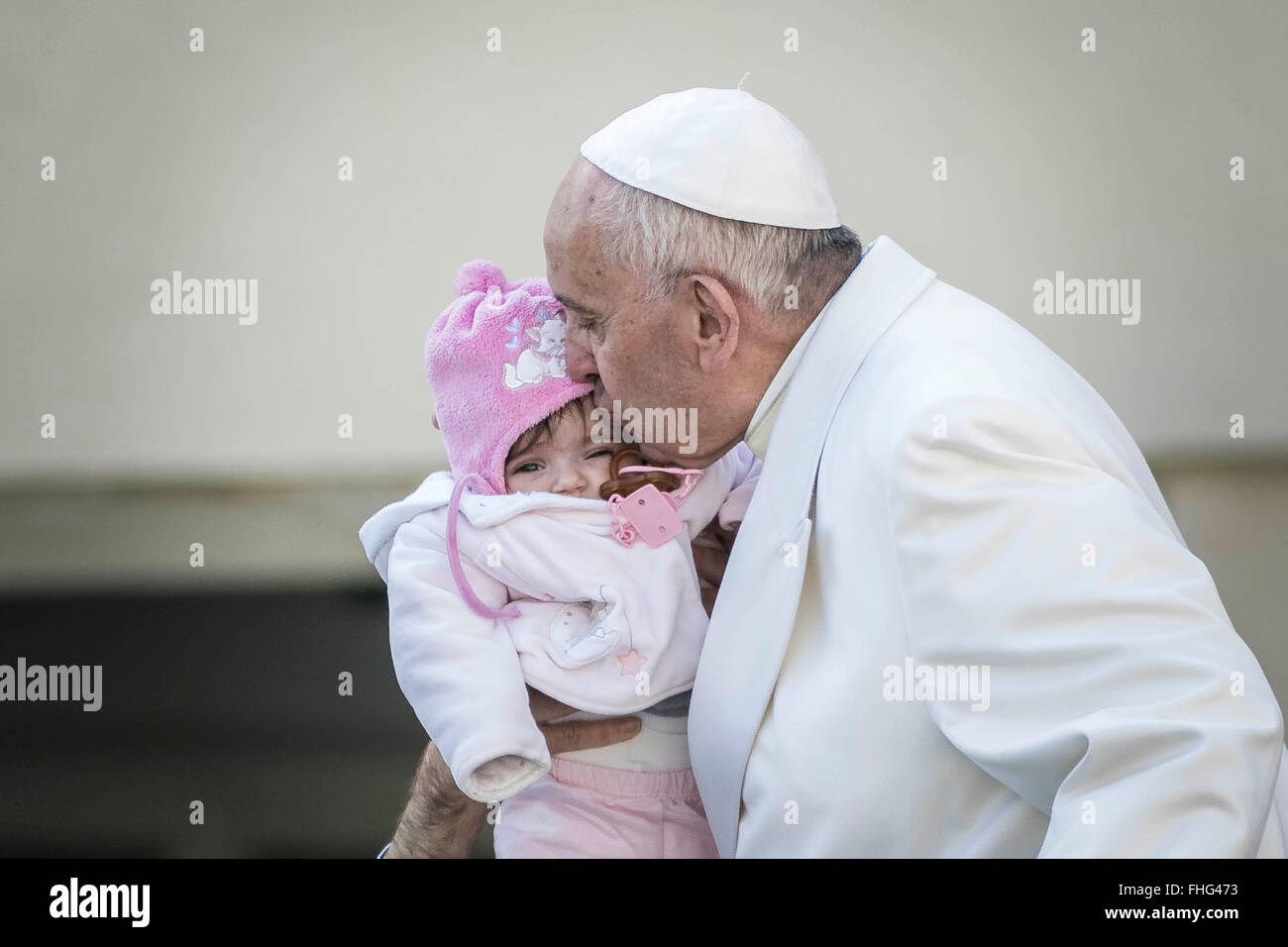 Pope Francis kisses a child as he arrives to hold his Weekly General ...