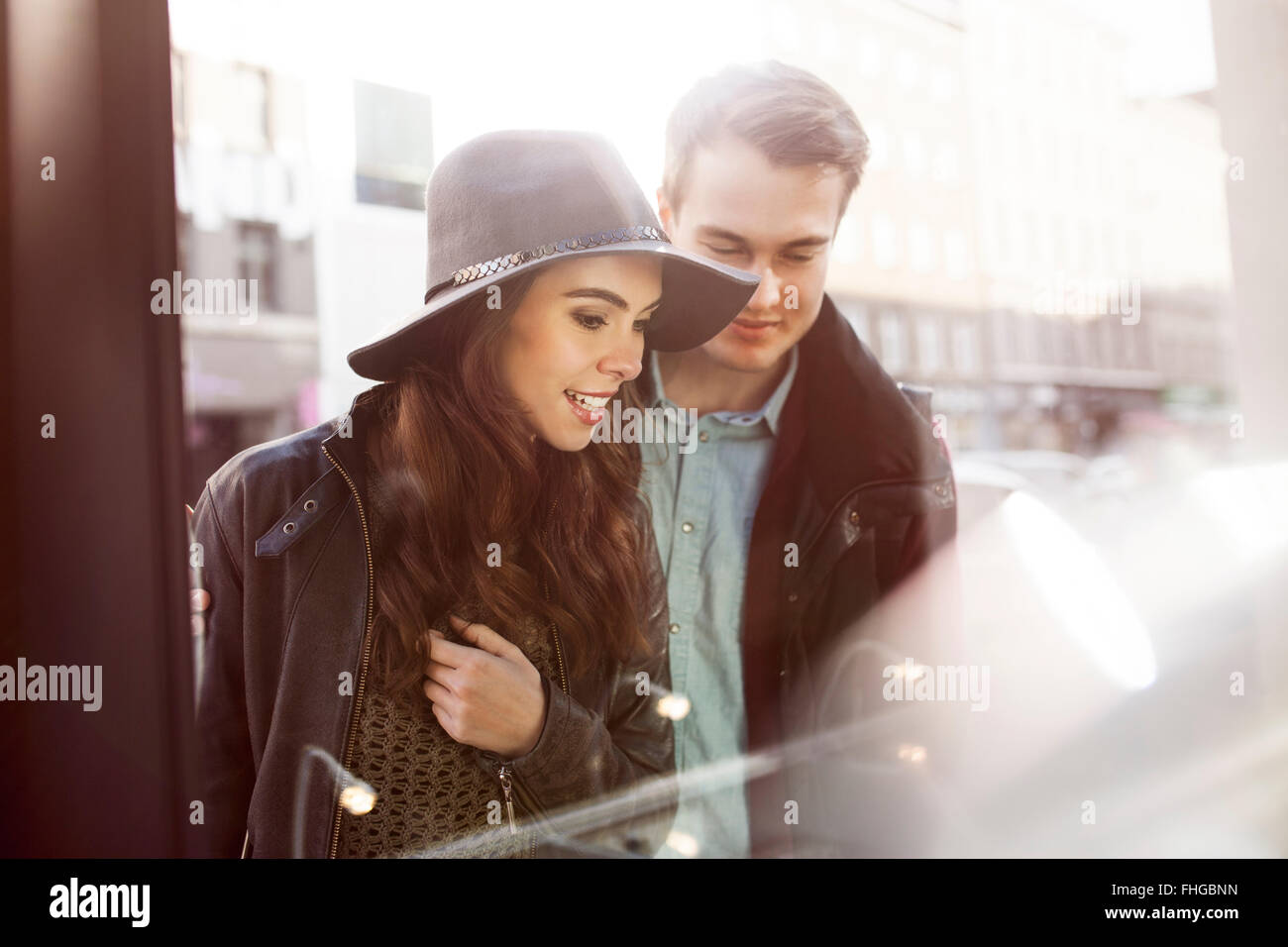 Young couple looking in shop window Stock Photo - Alamy
