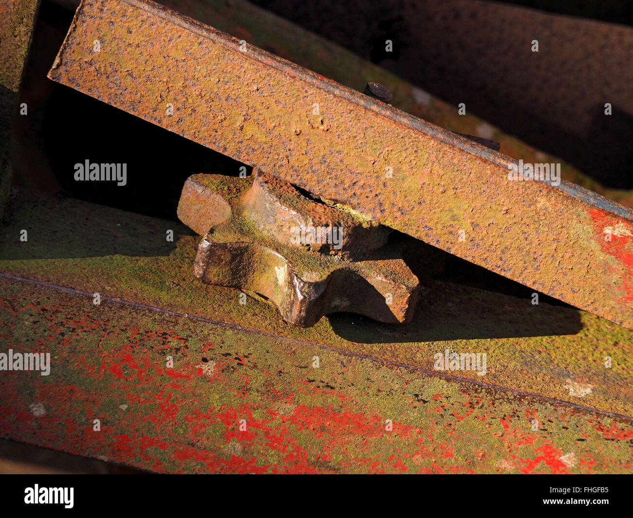 detail of rusty cog and bar as part of disused abandoned agricultural ...