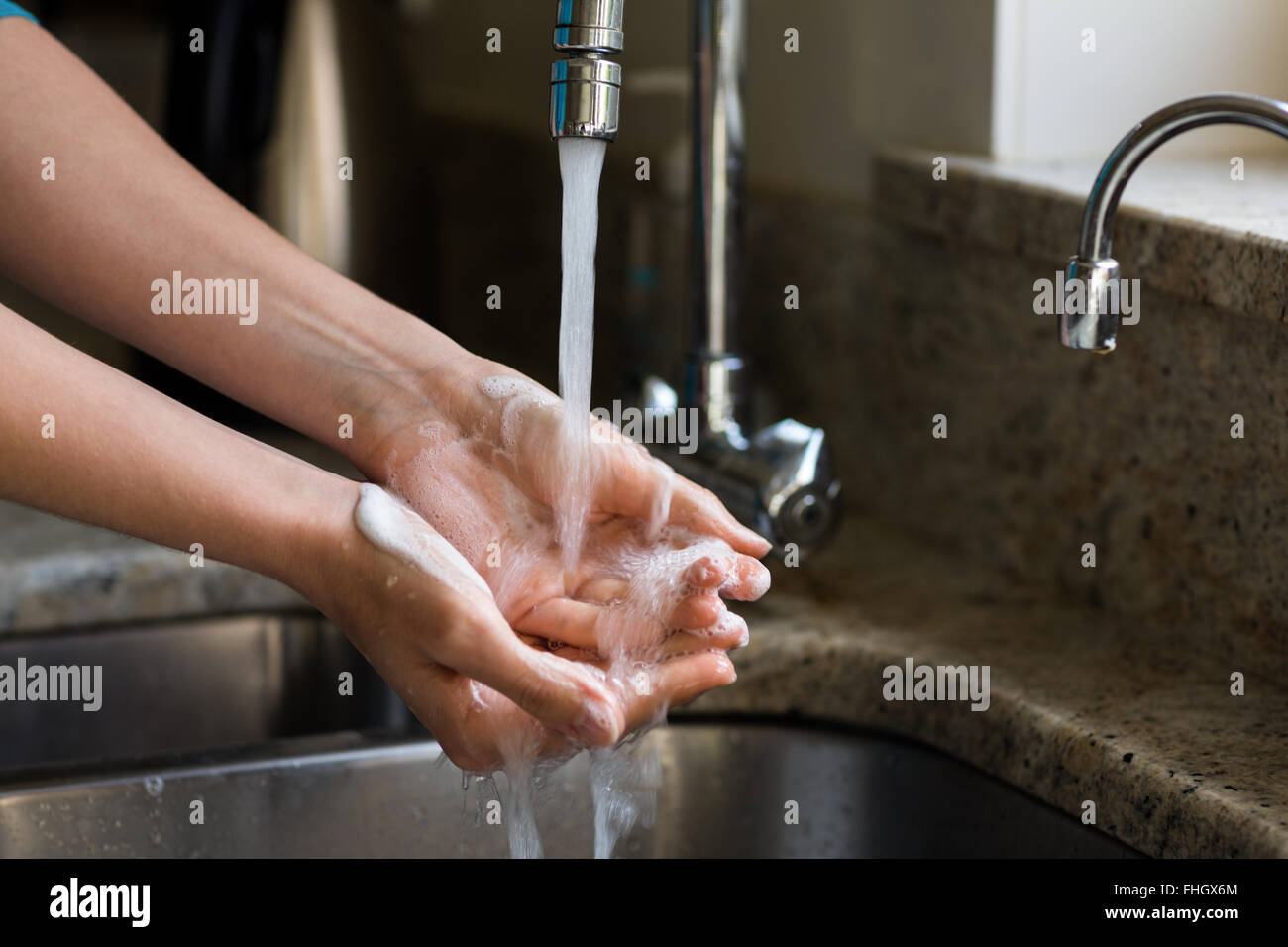 Pretty woman washing her hands Stock Photo - Alamy