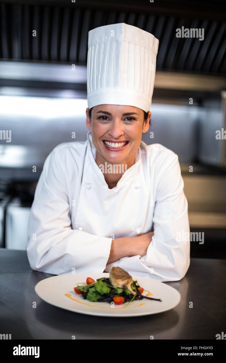Happy chef showing her dish Stock Photo - Alamy