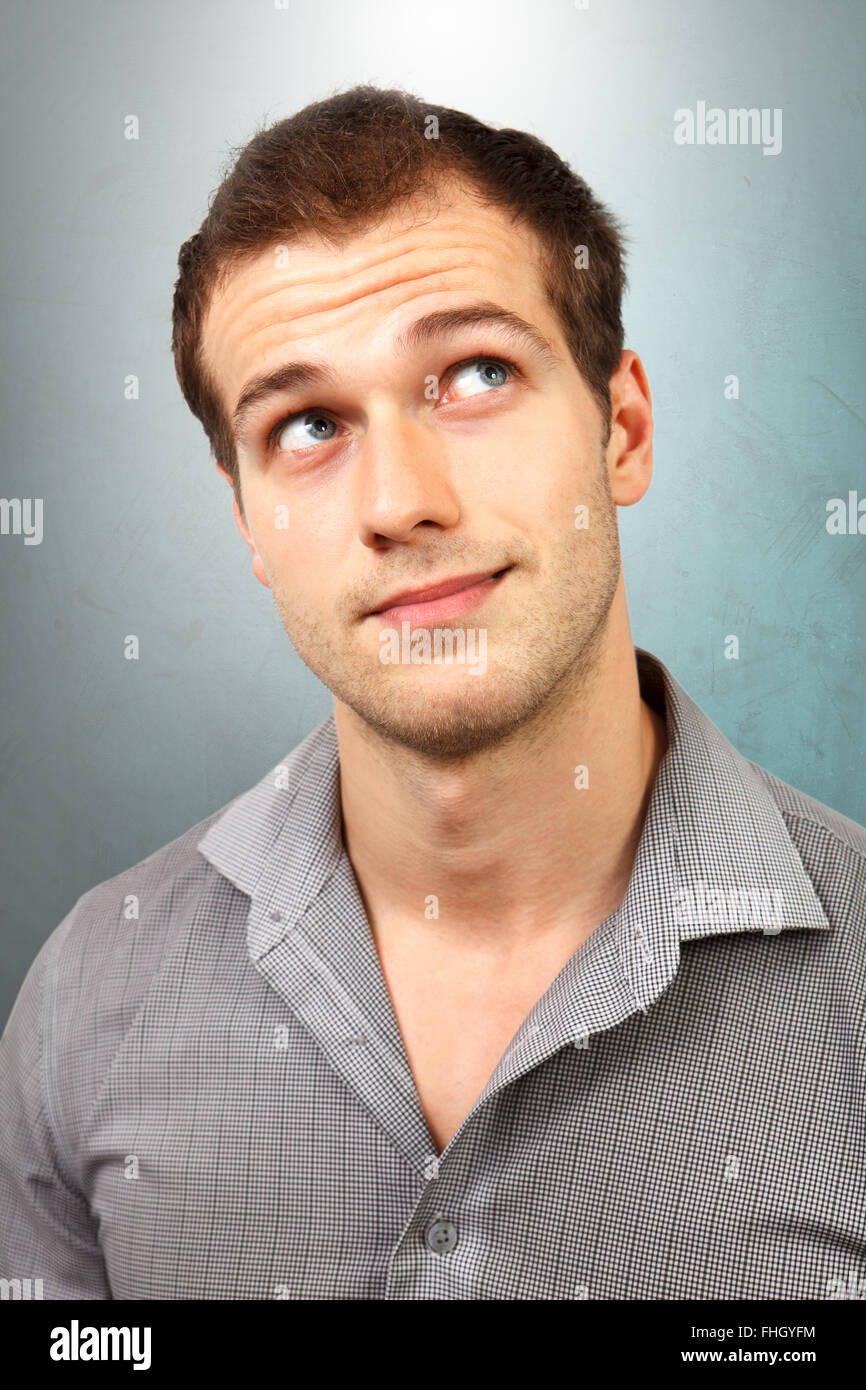 Pensive thinking young man looking up Stock Photo - Alamy