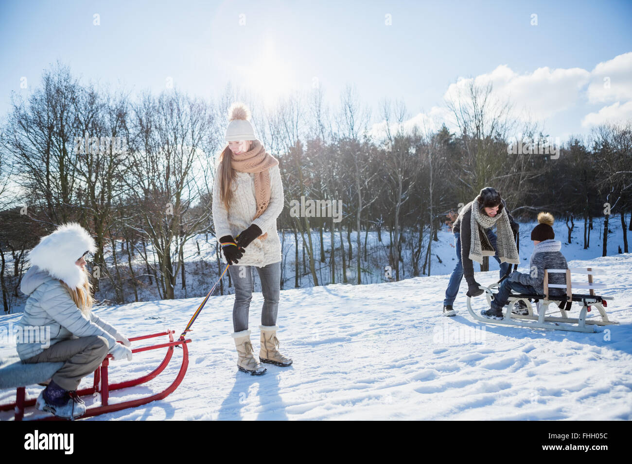 Family playing with sled Stock Photo - Alamy